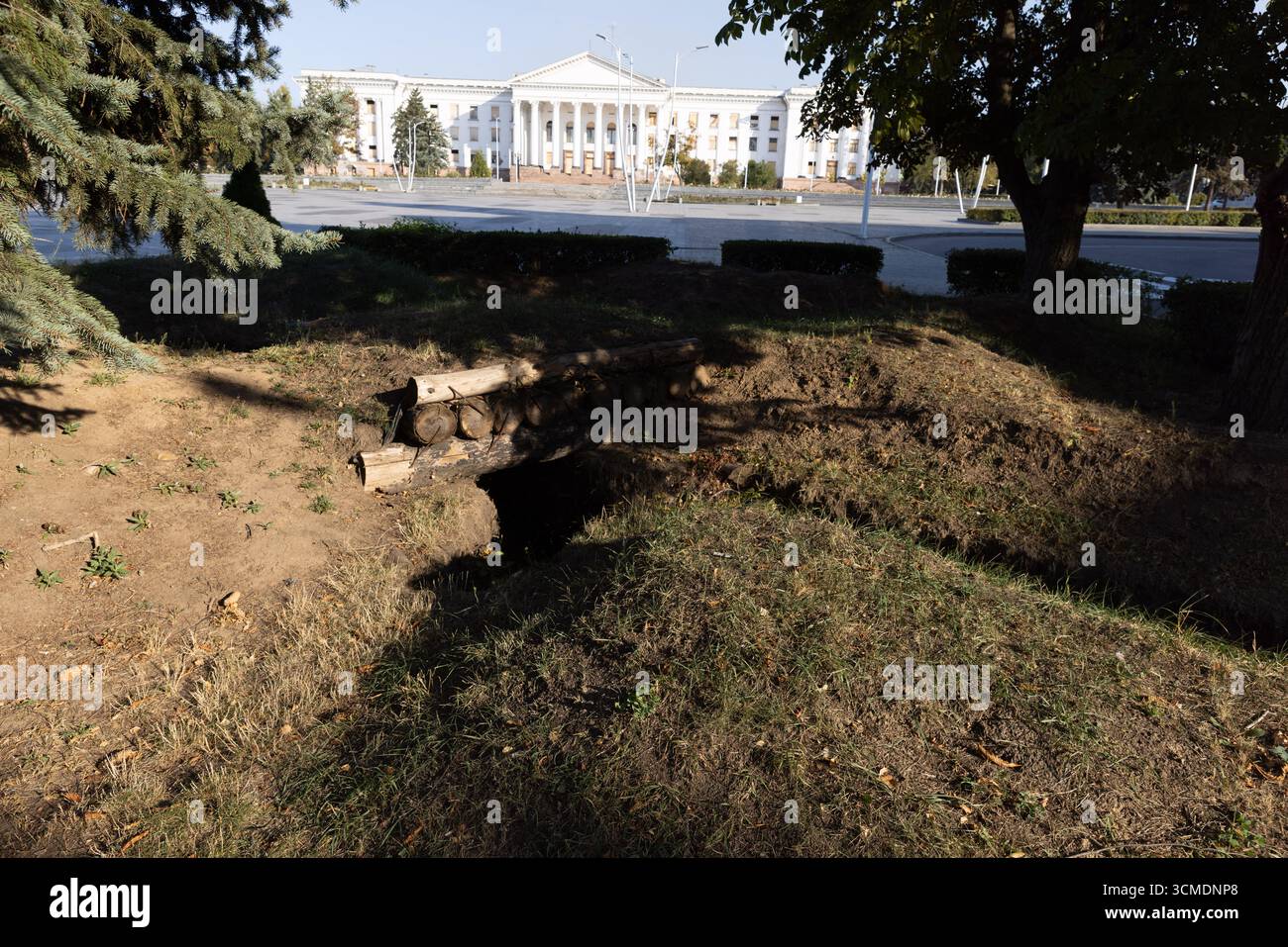 People walk among damaged residential buildings after a Russian strike ...