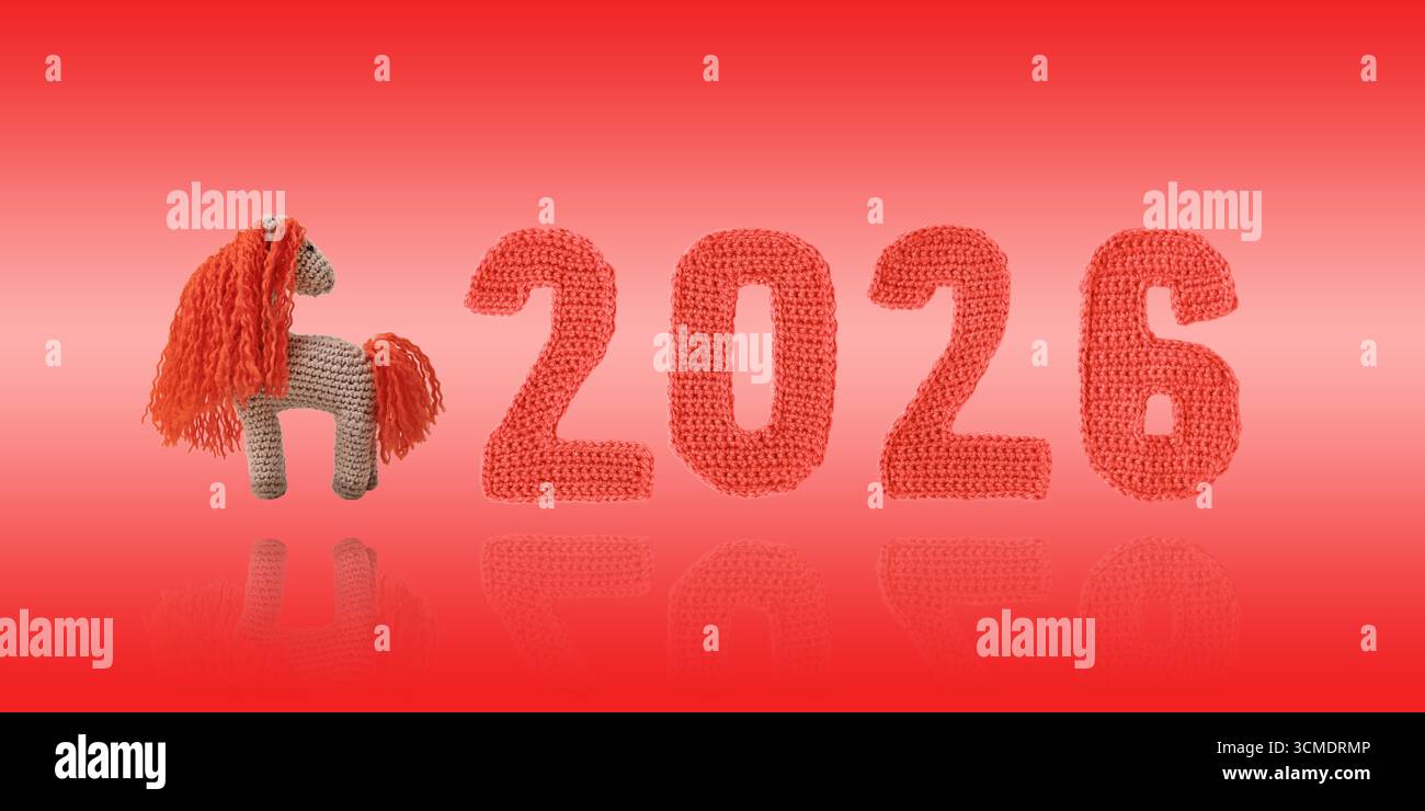 Crocheted toy funny fiery red horse and knitted green numbers. The ...