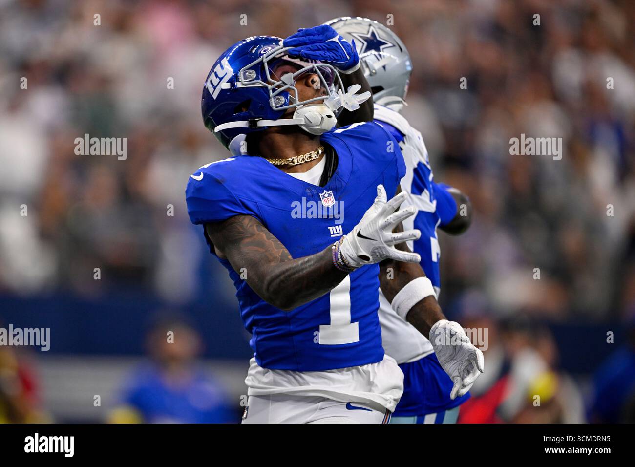 Dallas Cowboys cornerback Kaiir Elam (20) covers the helmet face mask ...