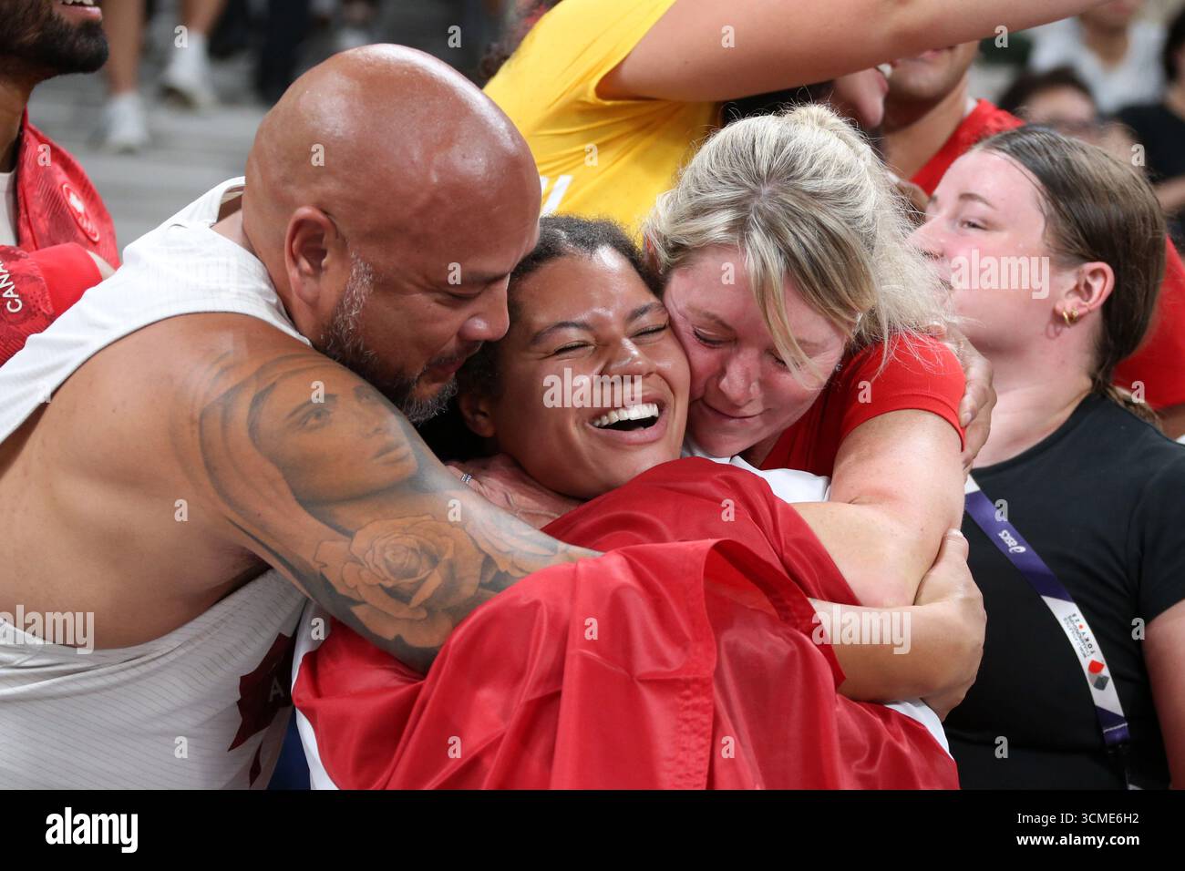 Camryn Rogers (CAN) is embraced by mother Shari Rogers and stepfather ...