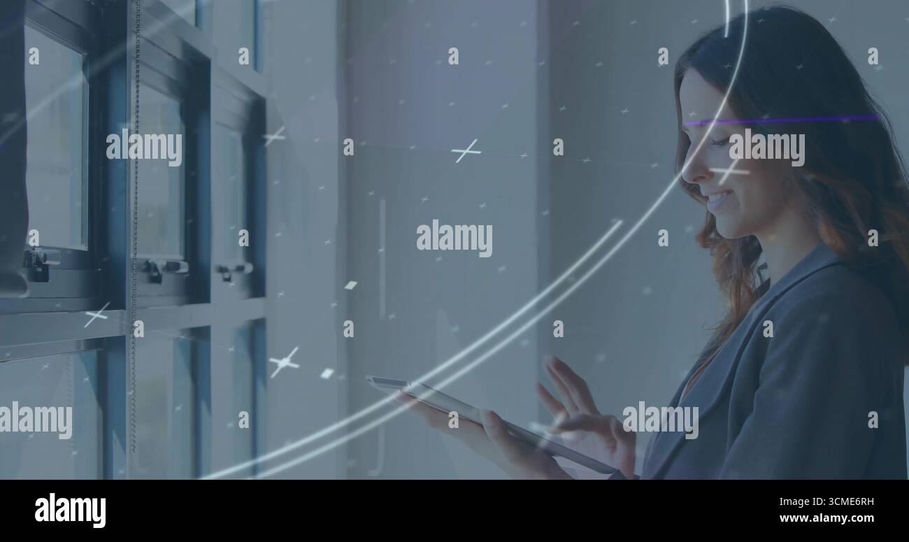 Tapping woman in blazer using tablet at office windows, with digital ...