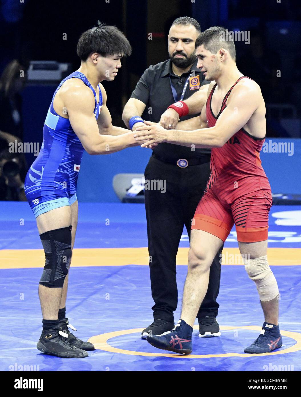 Kota Takahashi (L) of Japan shake hands with Chermen Valiev of Albania ...