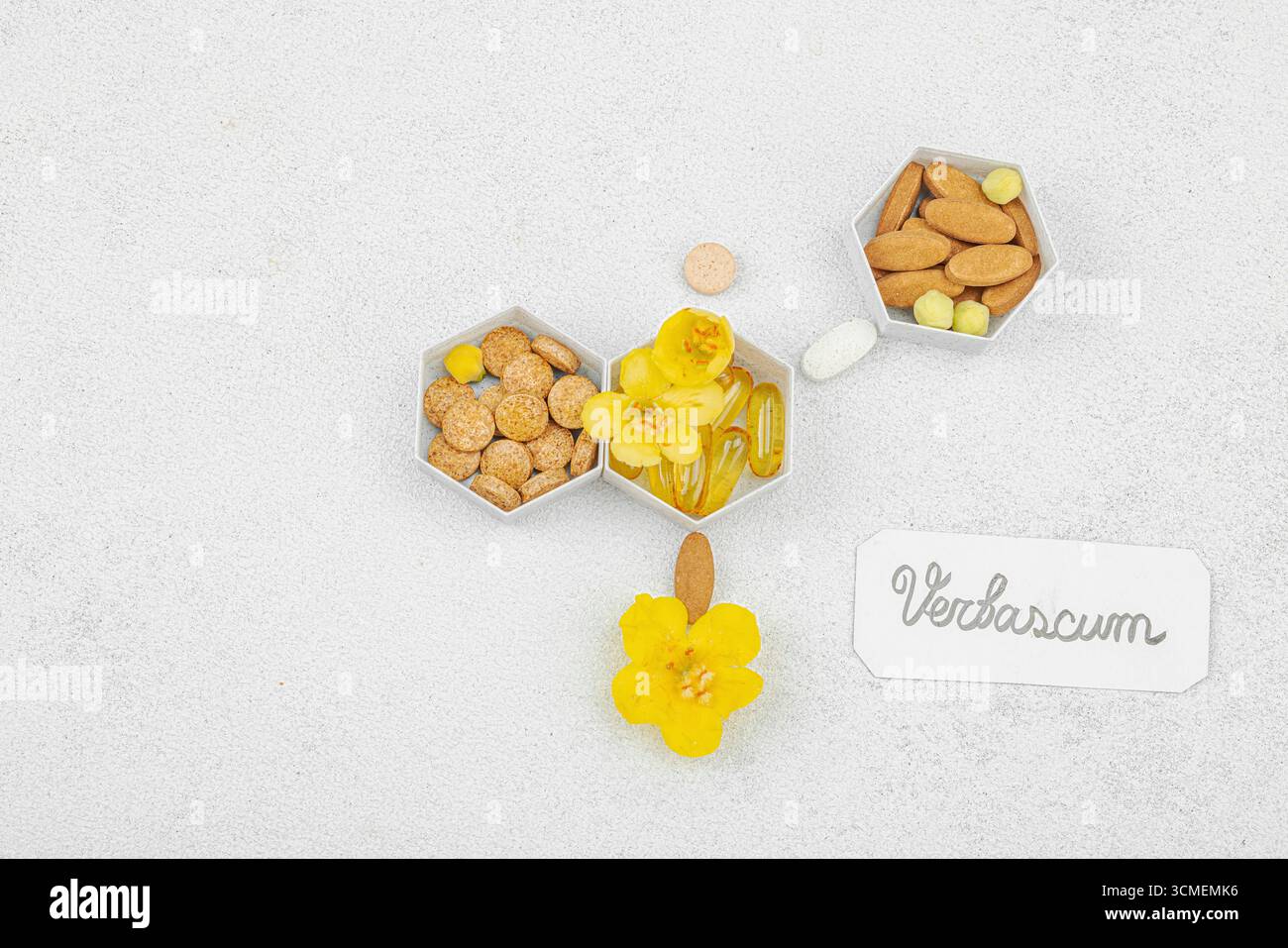 Hexagonal containers filled with capsules, tablets, and fresh Verbascum ...