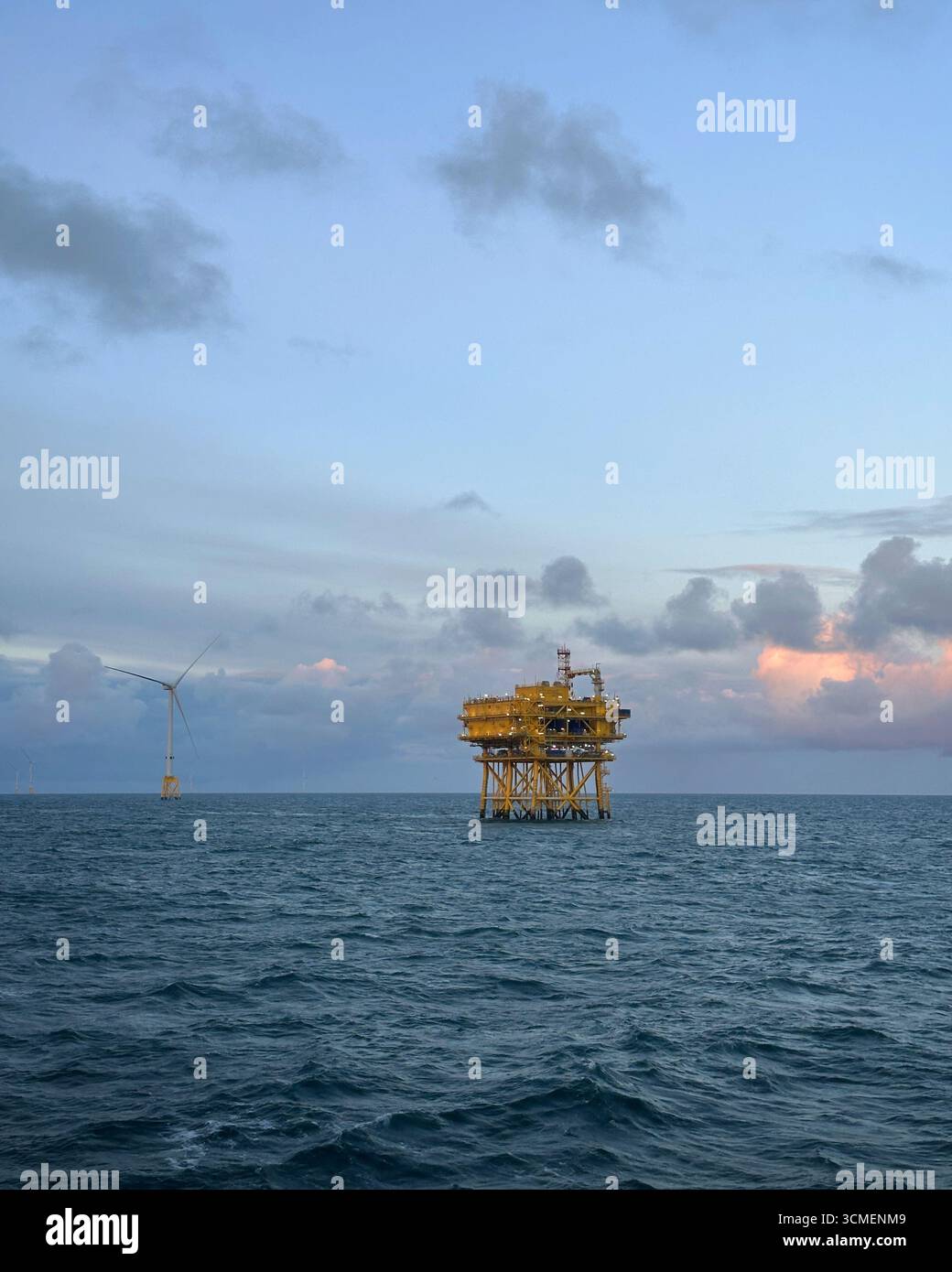 Offshore wind farm substation platform in the North Sea at sunset ...