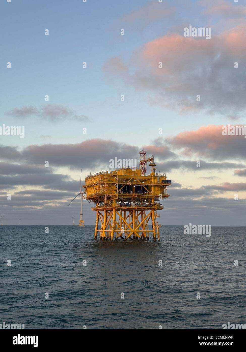 Offshore wind farm substation platform in the North Sea at sunset ...