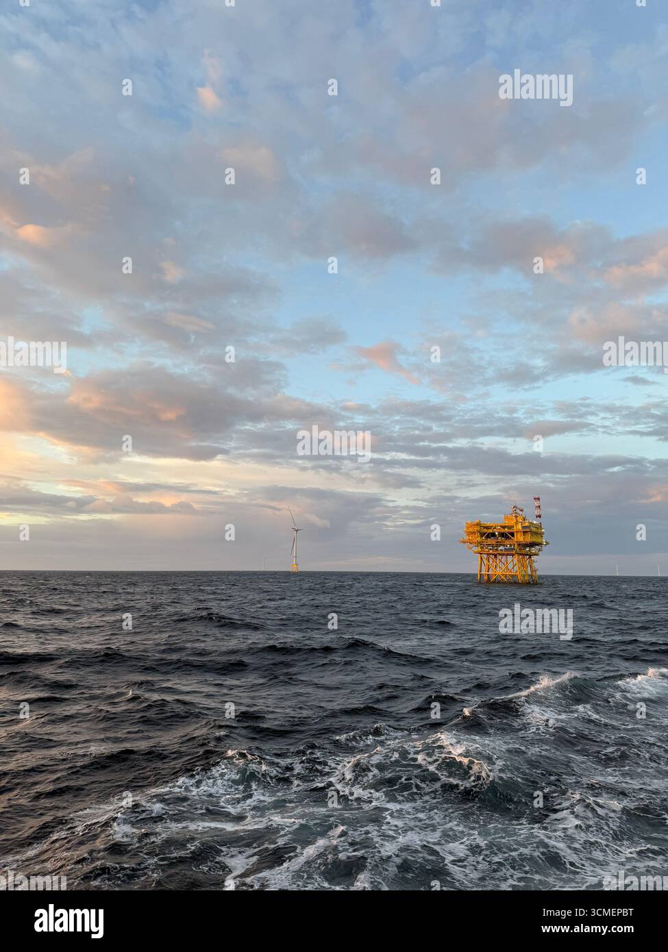Offshore wind farm substation platform in the North Sea at sunset ...