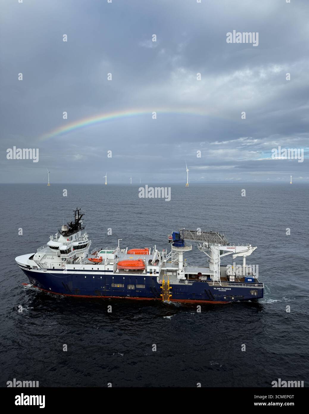 Offshore support vessel Island Diligence with rainbow over North Sea ...
