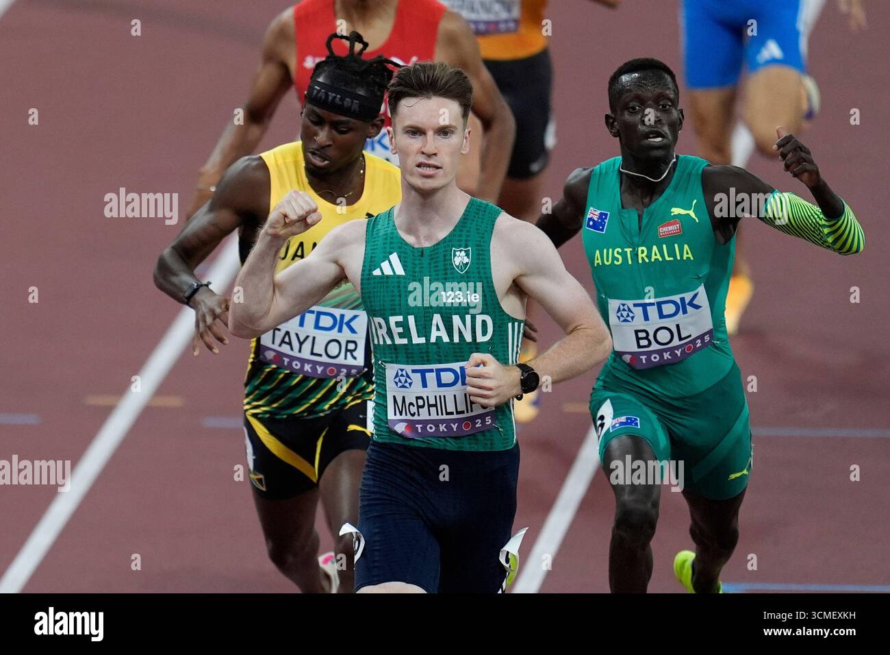 Ireland's Cian McPhillips, center, crosses the finish line to win the ...