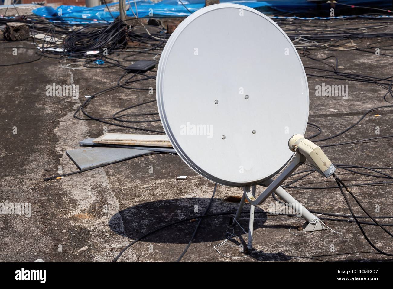 Old satellite antenna dish for television on the rooftop of a ...