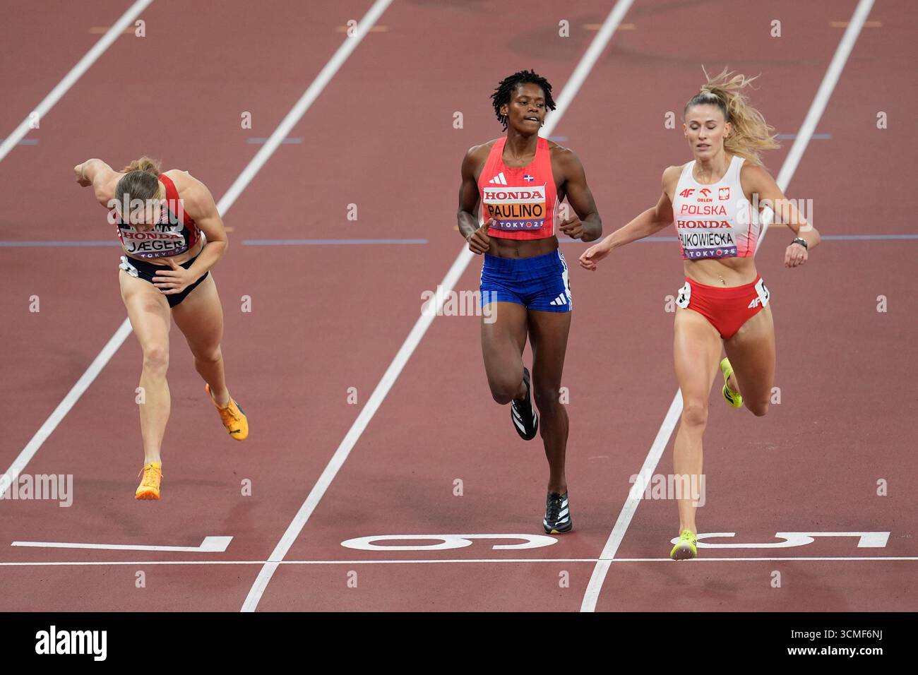 Poland's Natalia Bukowiecka, right, crosses the finish line with Dominican Republic's Marileidy ...