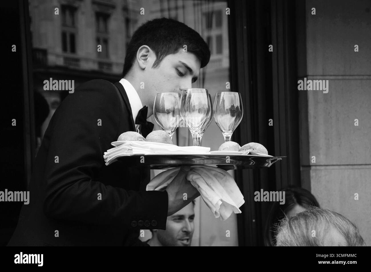 PARIS, FRANCE - APRIL 20, 2014 : Waiter serving food and drinks to ...