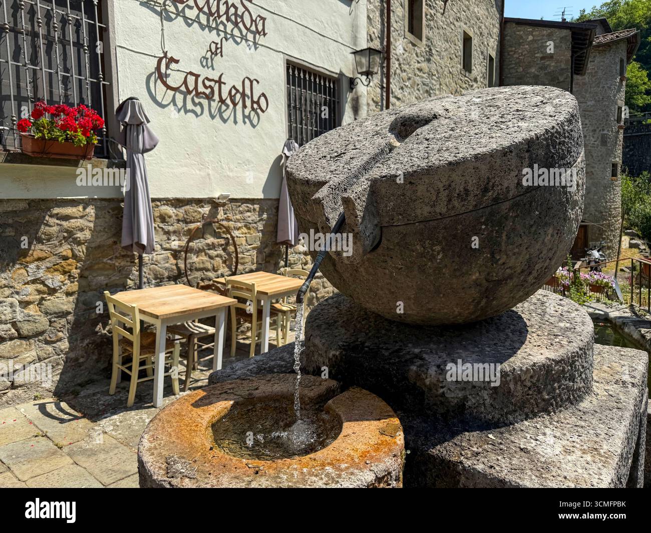 A stone water fountain near the main gate into the Castello della ...