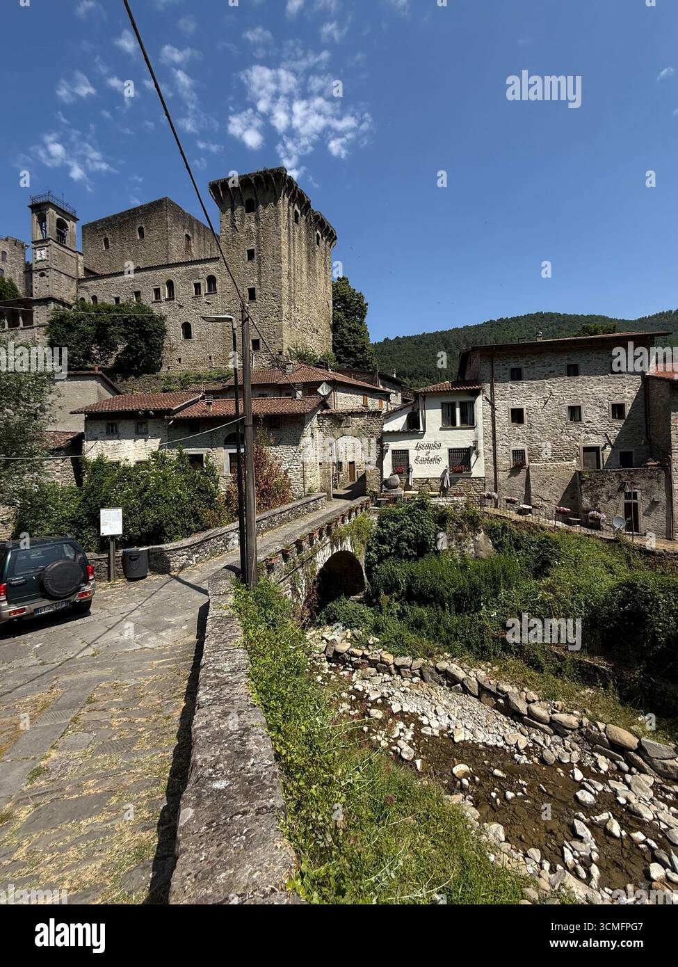 Across the bridge over a narrow river towards the main arch entrance ...