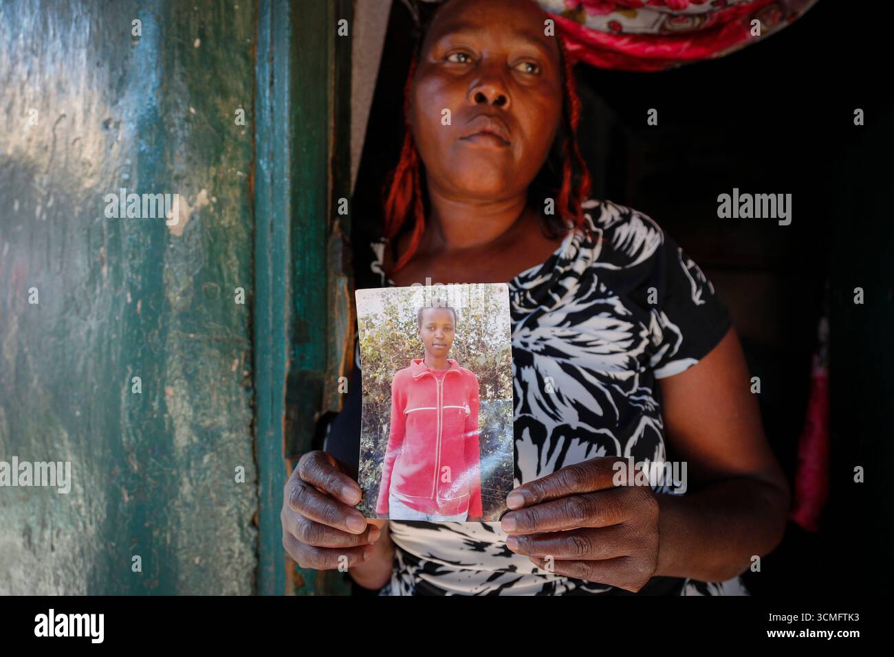 FILE - Rose Wanyua Wanjiku, elder sister to Agnes Wanjiru, 20, holds a ...