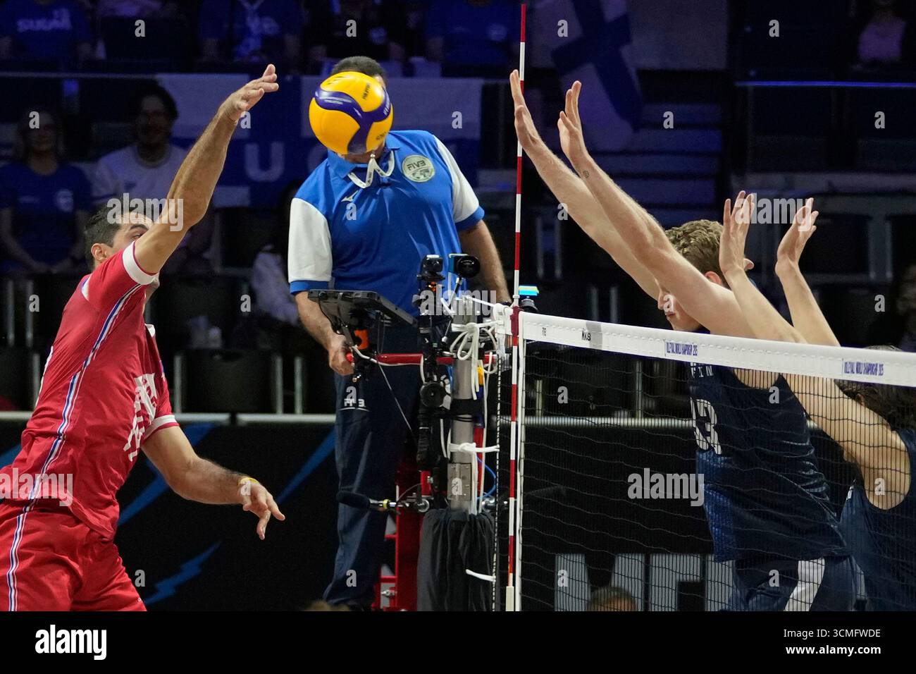 Yacine Louati, left, of France spikes the ball against Finland during ...