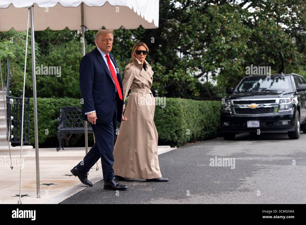 President Donald Trump and first lady Melania Trump walk out of the ...