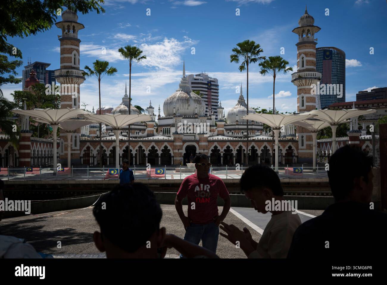 People take pictures outside the Jamek mosque in Kuala Lumpur, Malaysia ...
