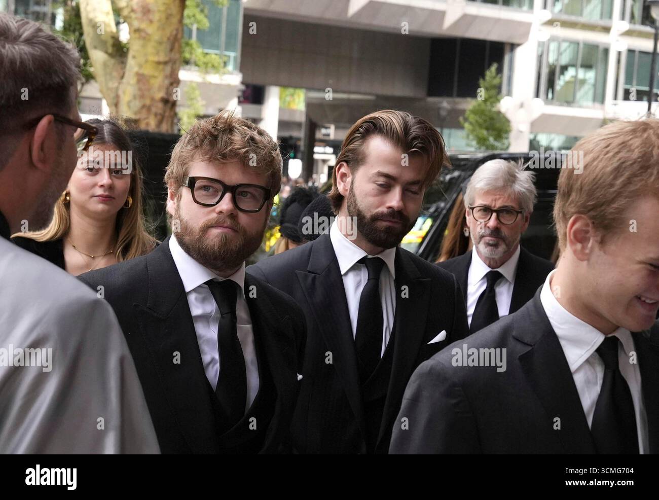 Columbus Taylor, center left, and Cassius Taylor, center right, arrive ...