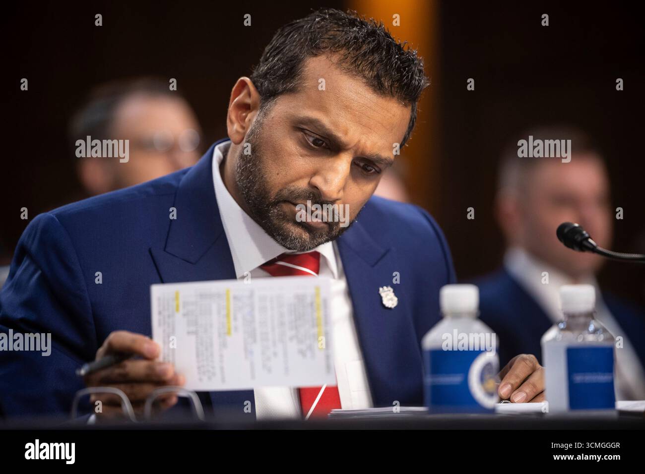 Federal Bureau of Investigation (FBI) Director Kash Patel consults his ...