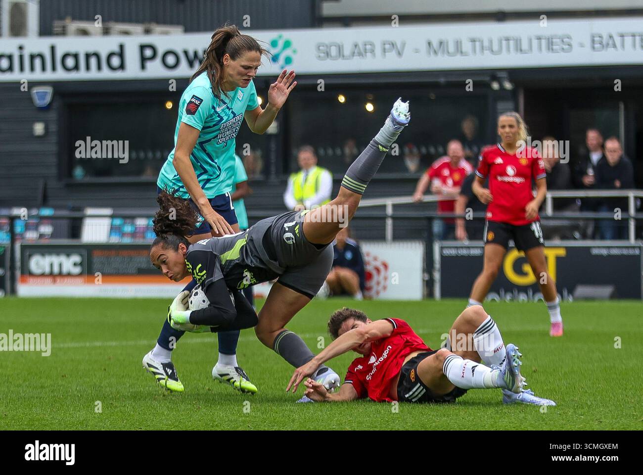 Manchester United goalkeeper Phallon Tullis-Joyce (right) collides with ...