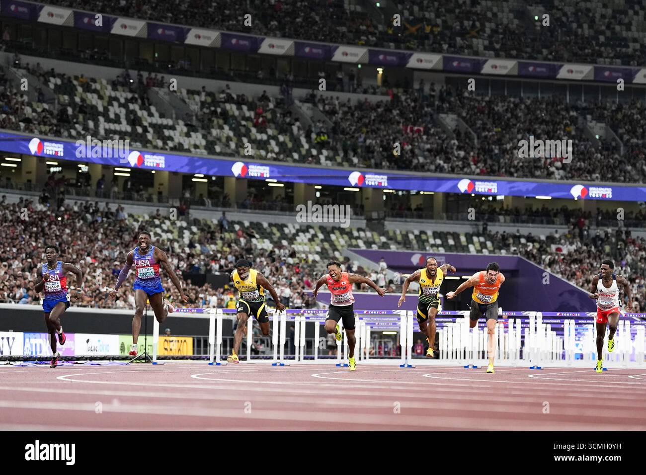 Athletes cross the finish line in the men's 110-meter hurdles final at ...