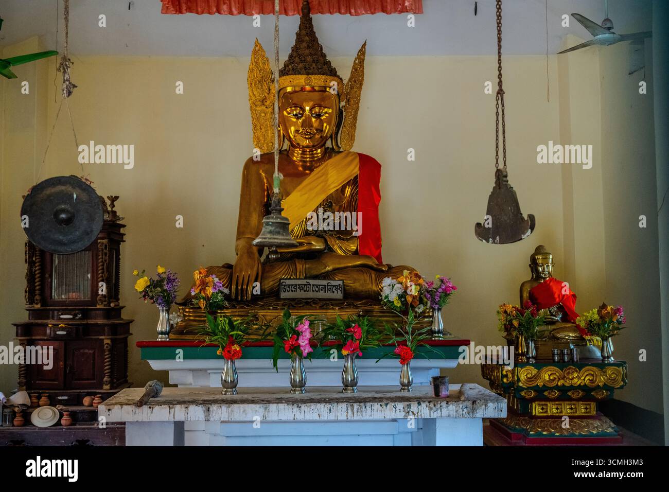 Golden Seated Buddha Statue with Ornate Decorations and Offerings at a ...