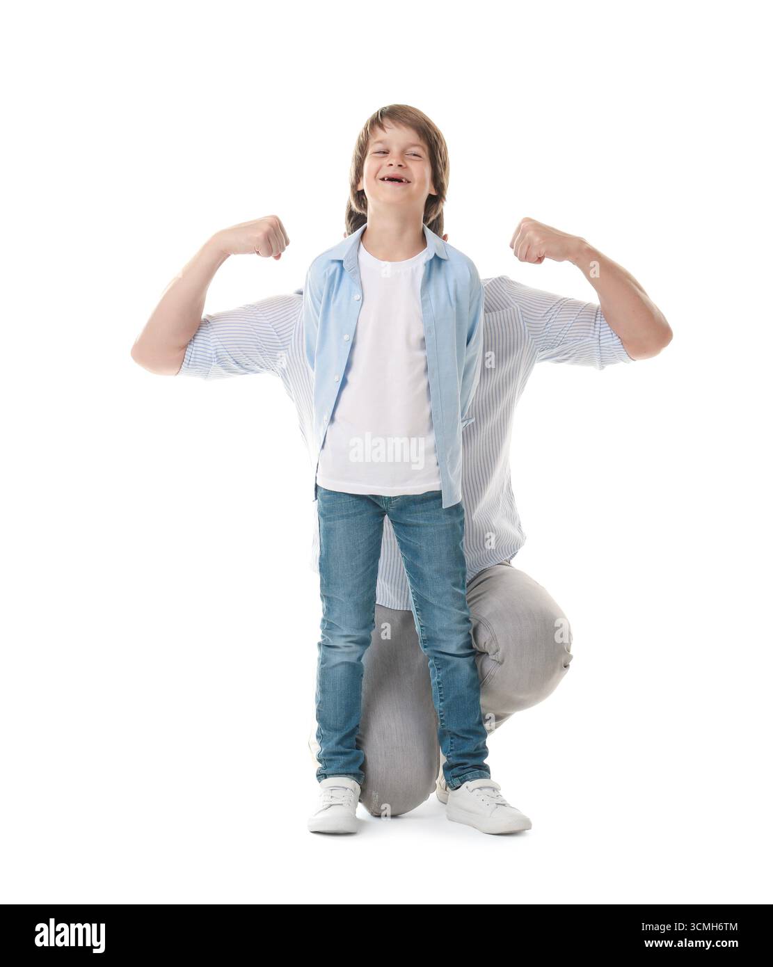 Son pretending to have big biceps with his father hiding behind him on ...