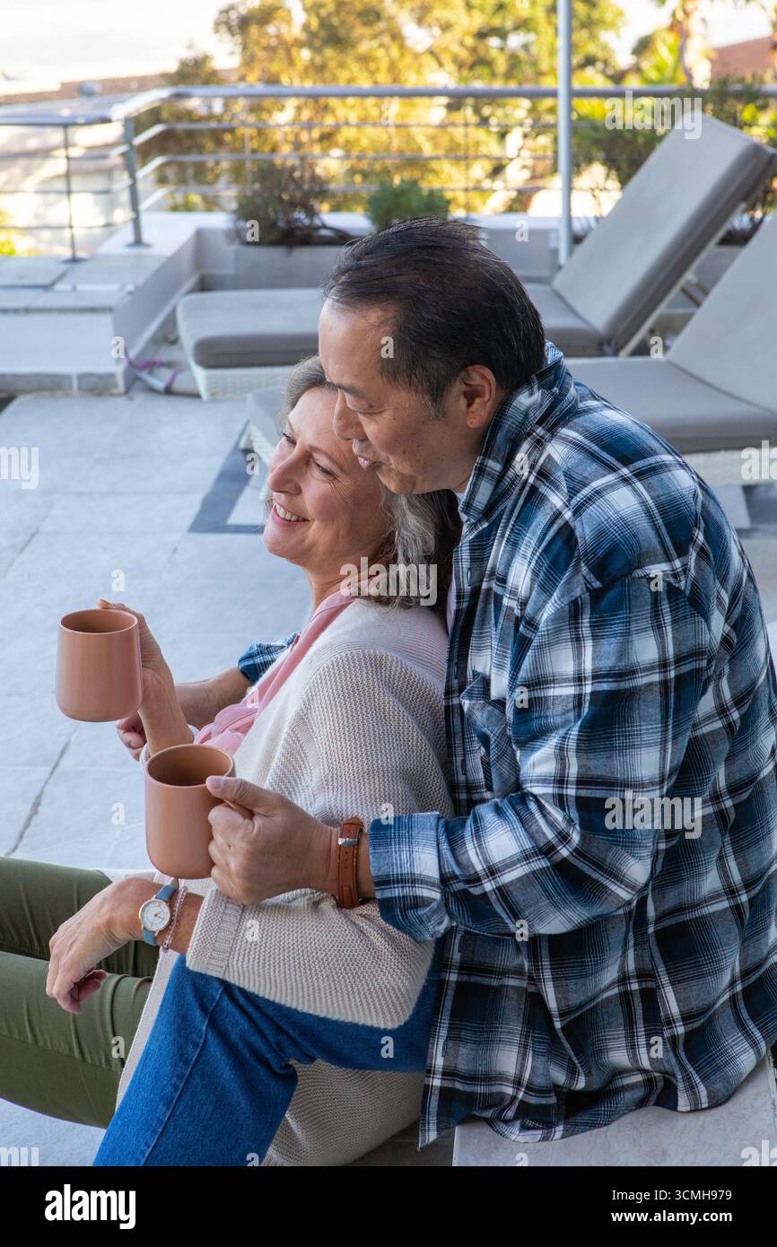 Diverse couple hugging sipping hi-res stock photography and images - Alamy