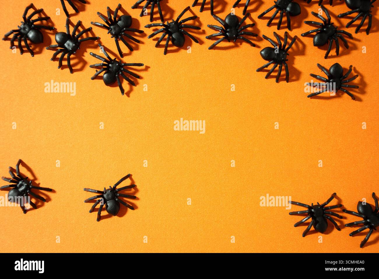 Fake spiders on an orange background. Halloween background Stock Photo ...
