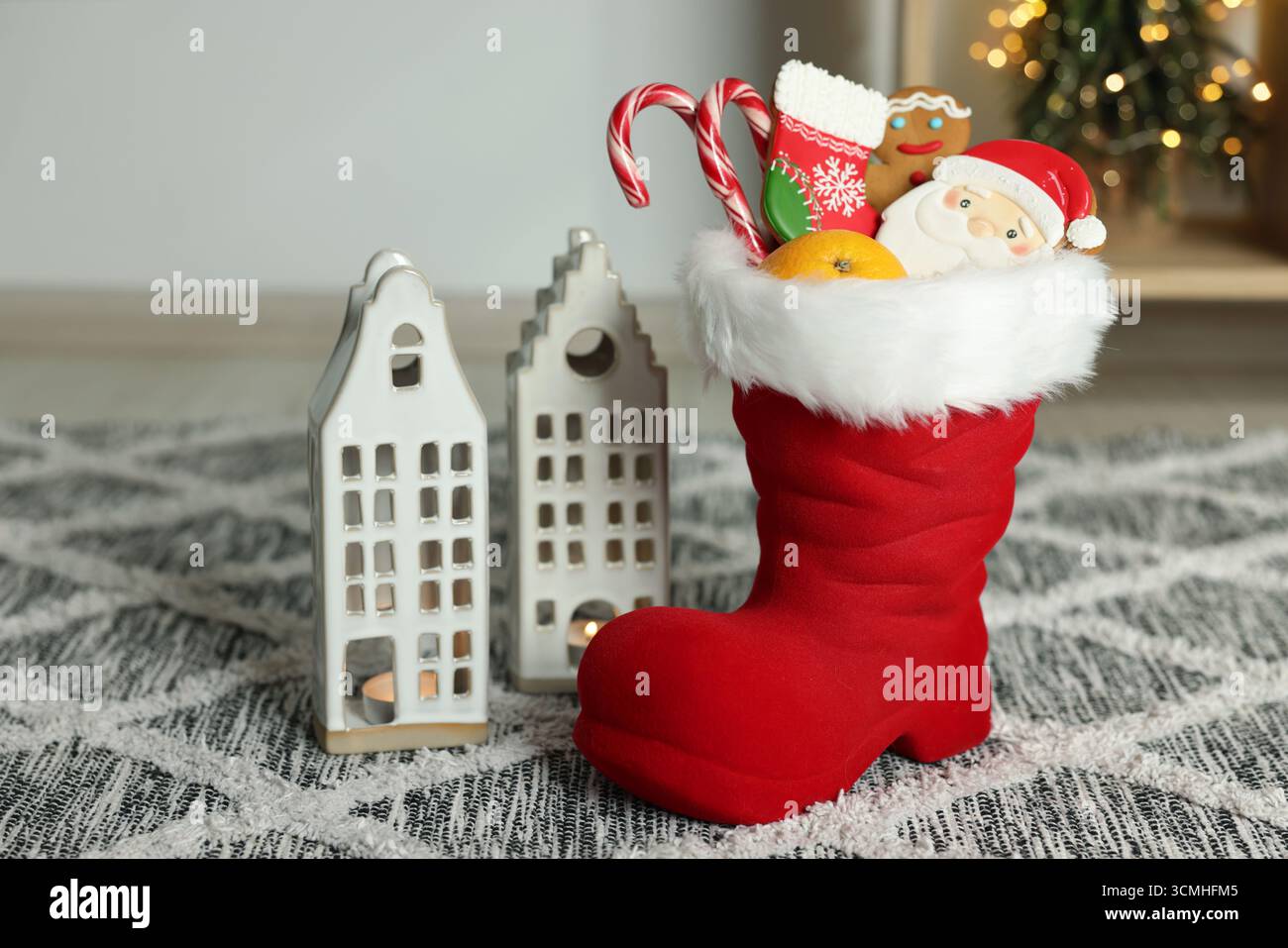 Saint Nicholas Day tradition. Red boot with treats and burning candles ...