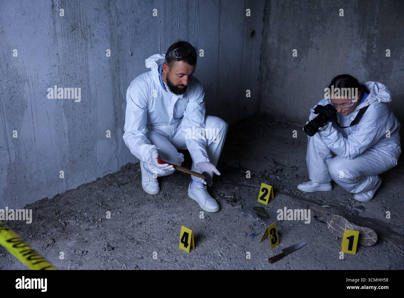 Forensic experts working at crime scene inside abandoned building Stock ...