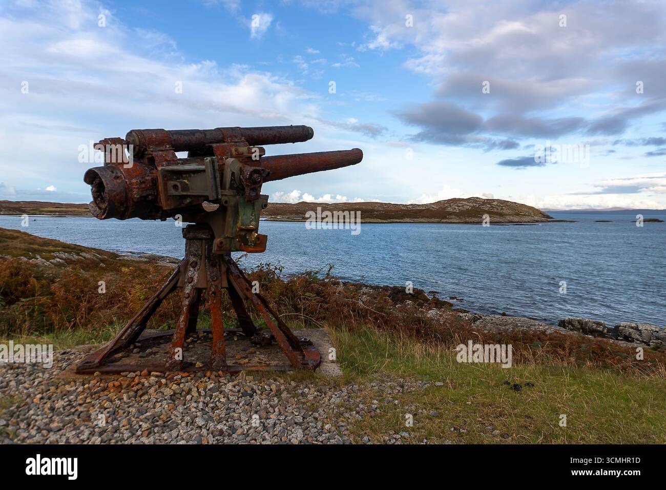 A WWII era deck gun from an armed merchant ship, overlooking the sea on ...