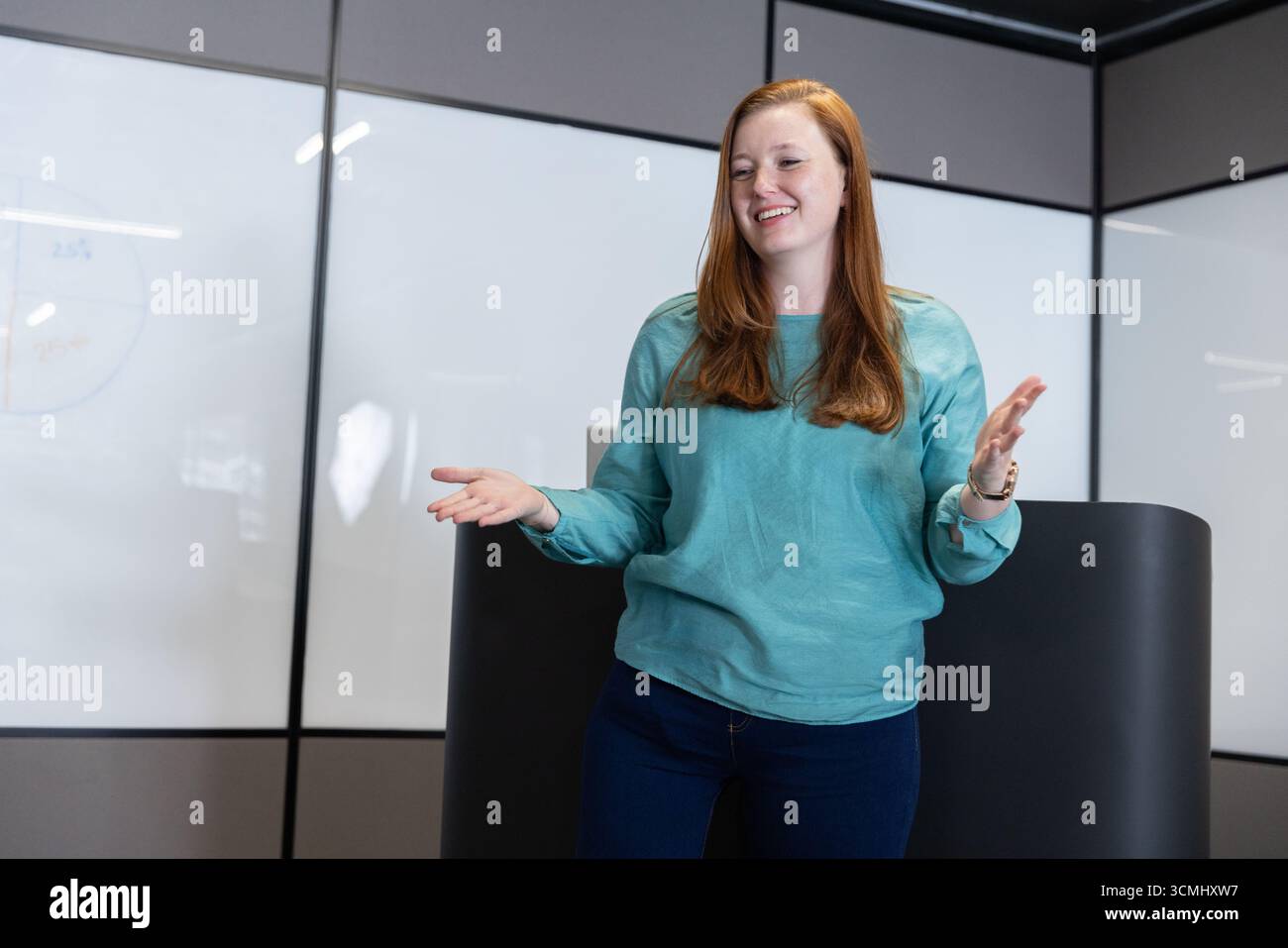 Female presenter presenting at lectern in corporate training room ...