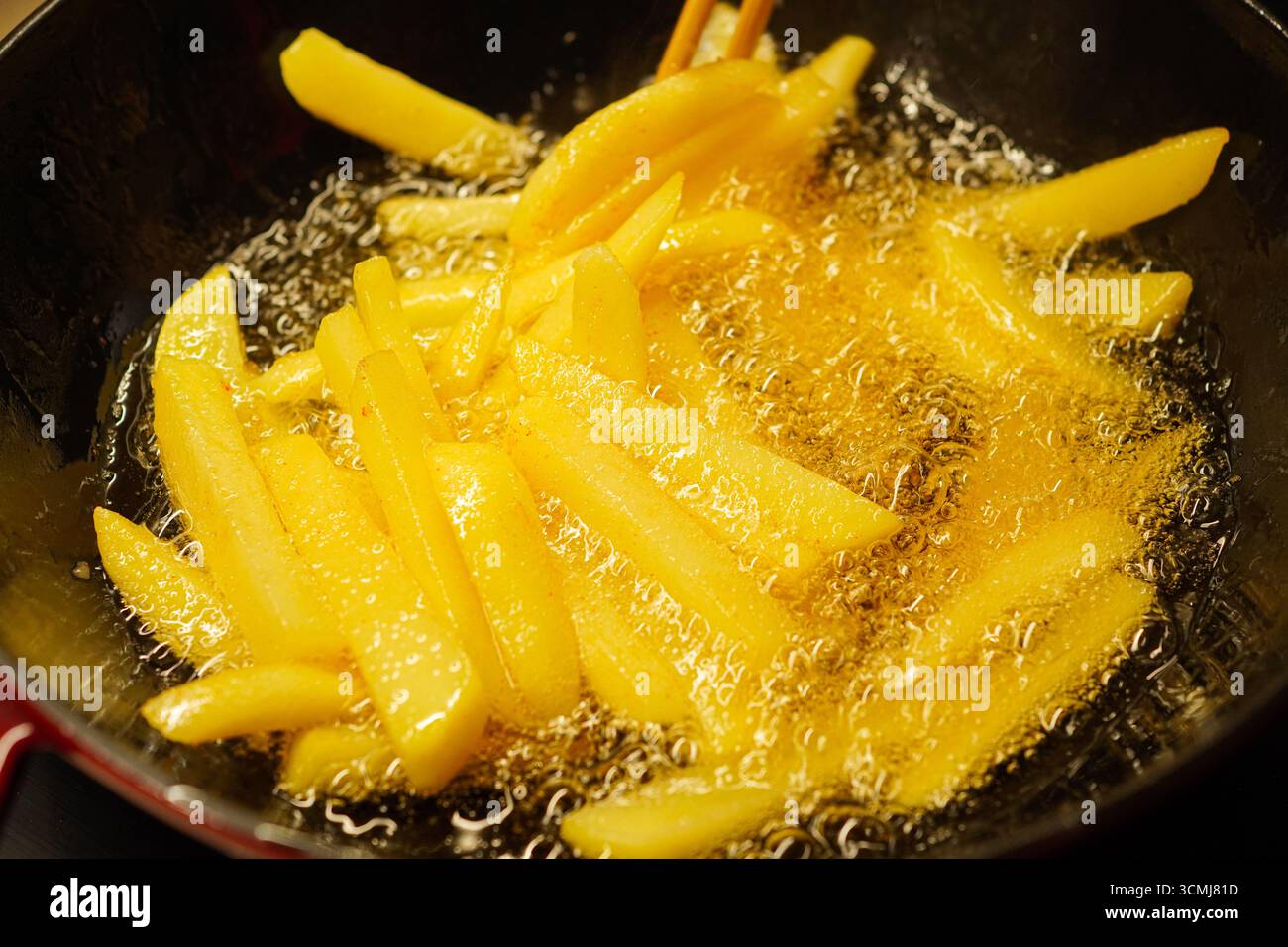 Deep-frying French fries in piping hot oil Stock Photo - Alamy