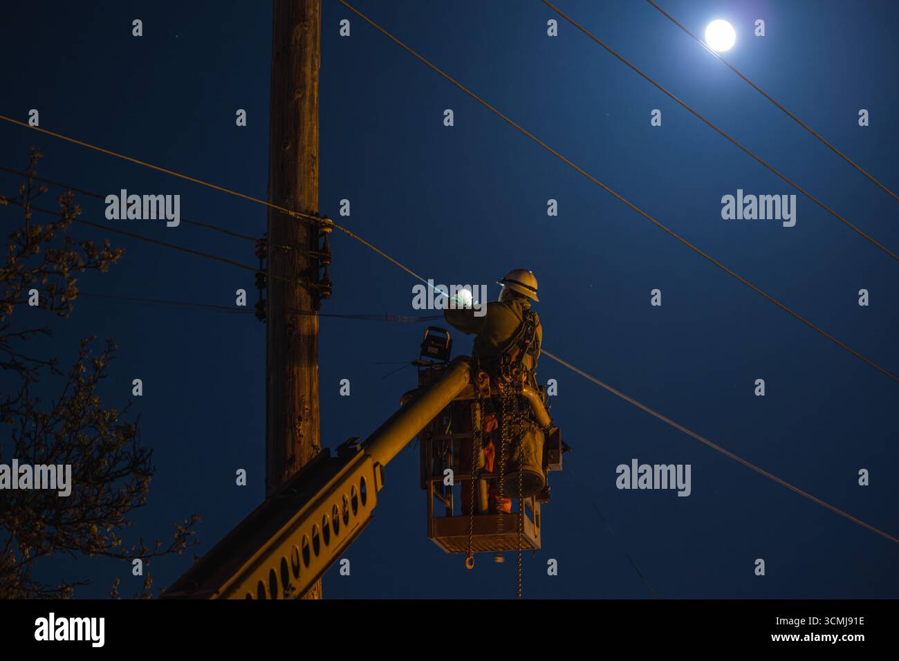 Photo of Elevated Electrical Worker Working on Electric Cables Stock ...