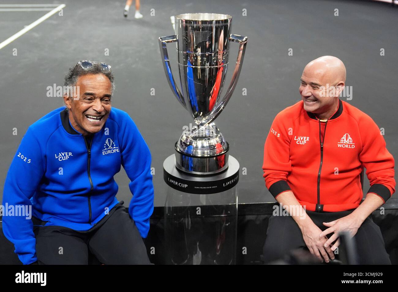 Team Europe captain Yannick Noah, left, laughs while being interviewed ...