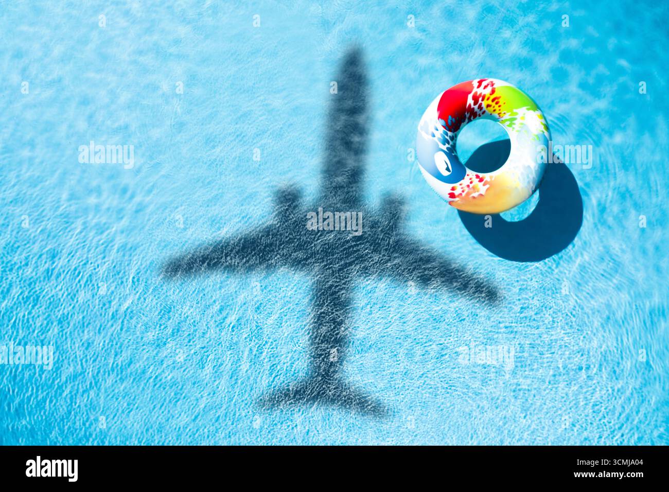 Inflatable ring floating in swimming pool, top view. Flying airplane ...