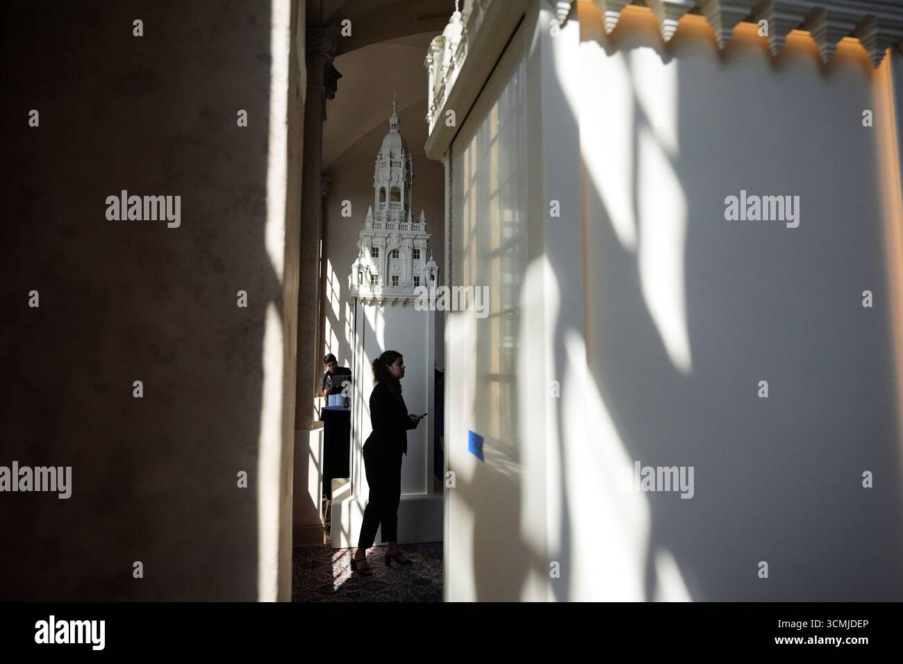 People stand alongside replicas of the Freedom Tower during an event ...