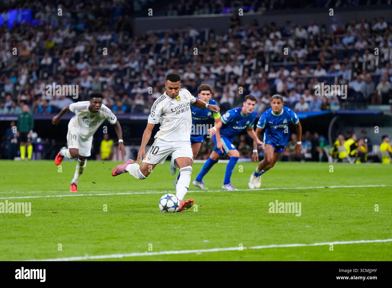 Real Madrid's Kylian Mbappe shoots a penalty kick to score his side's ...