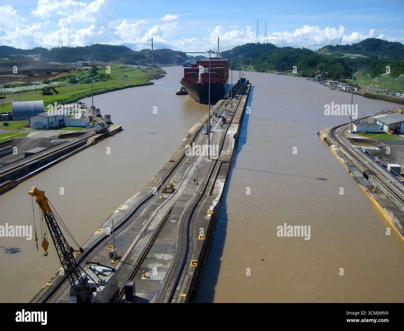 A panoramic view of the Panama Canal, showing a vessel navigating the ...