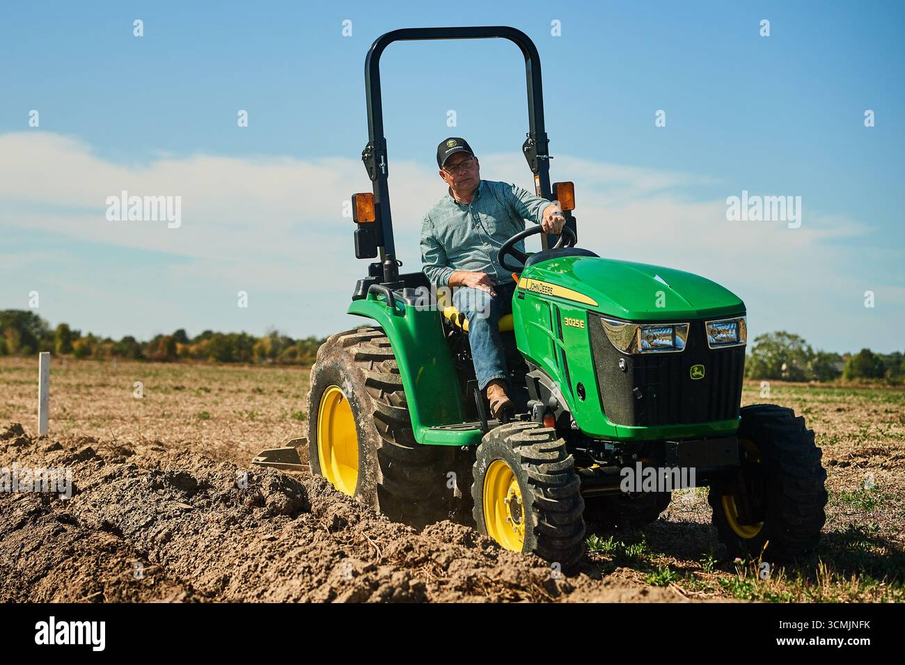 Ontario Green Party Leader Mike Schreiner plows a furrow with a tractor ...