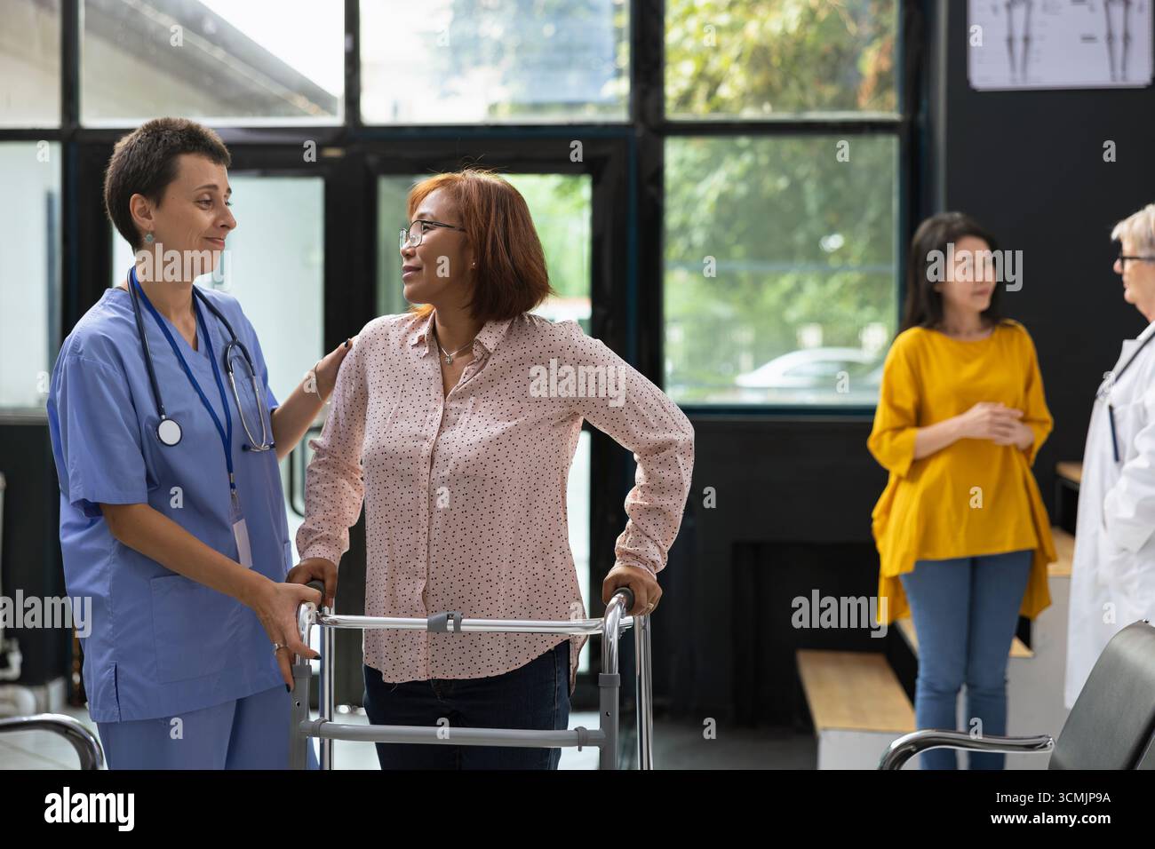 Medical nurse offers support and guidance to asian woman with locomotor problem, using a walking ...