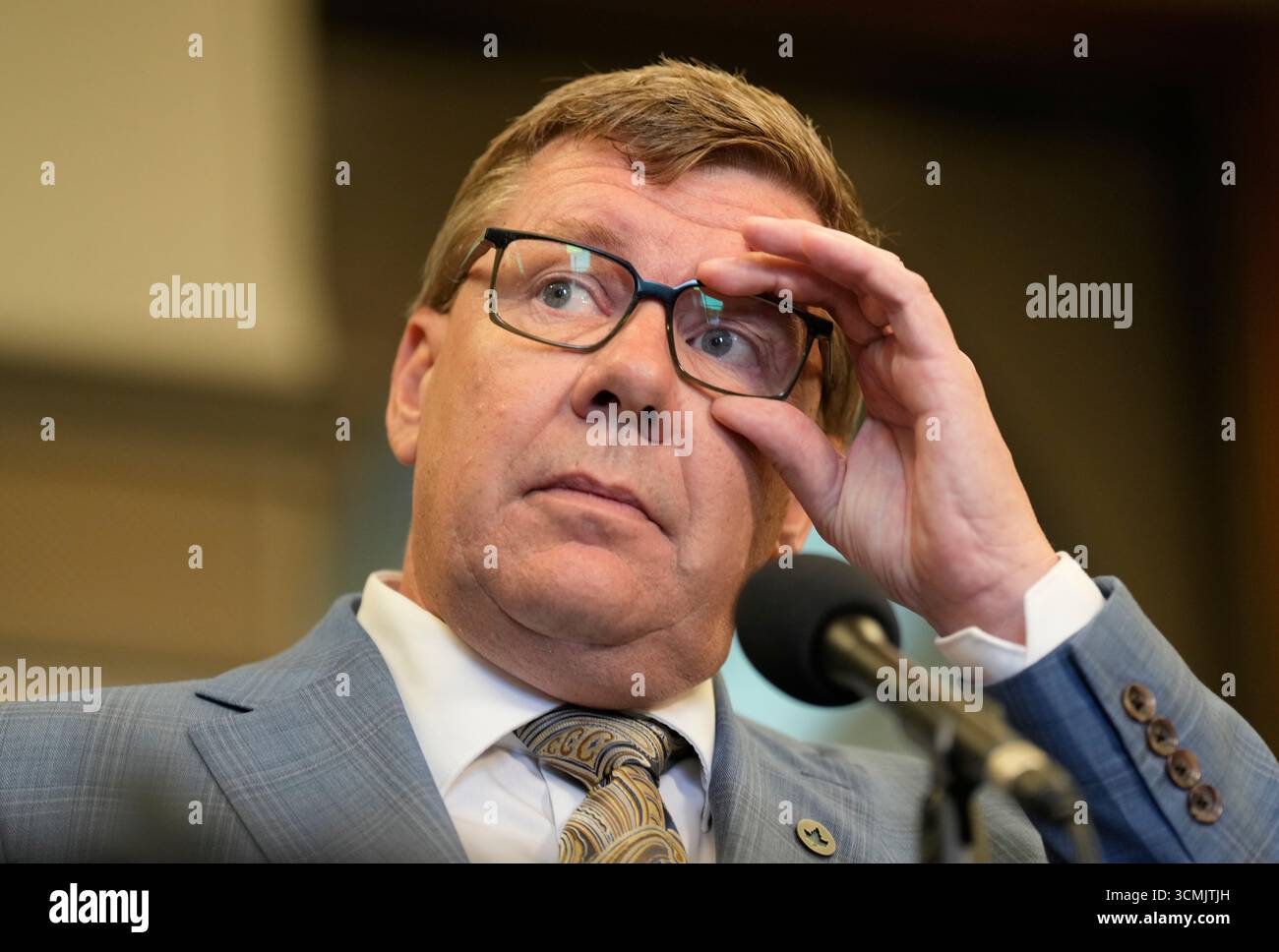 Saskatchewan Premier Scott Moe adjusts his glasses as he speaks with ...