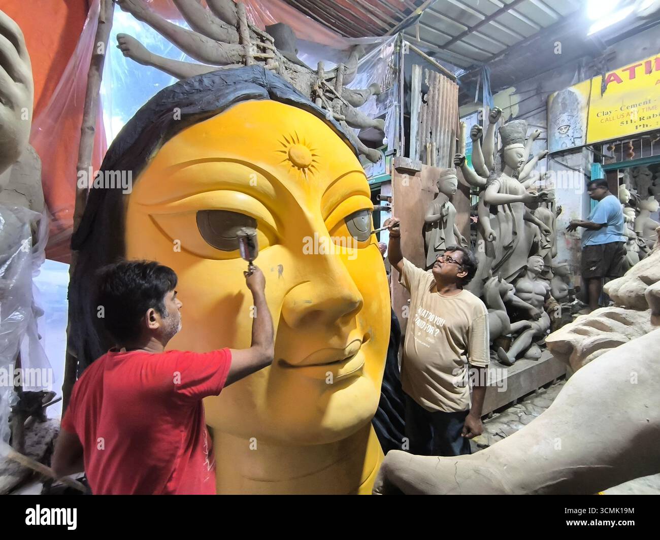 An idol maker works in a pottery hub before the Durga Puja festival in ...