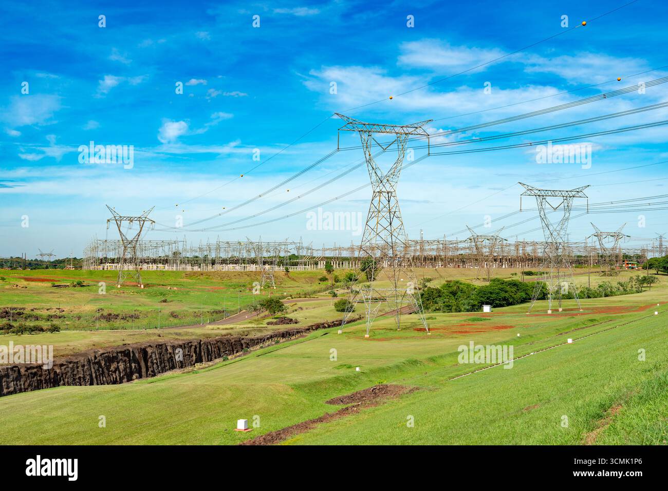 A wide view of a field in Brazil with high voltage power lines ...