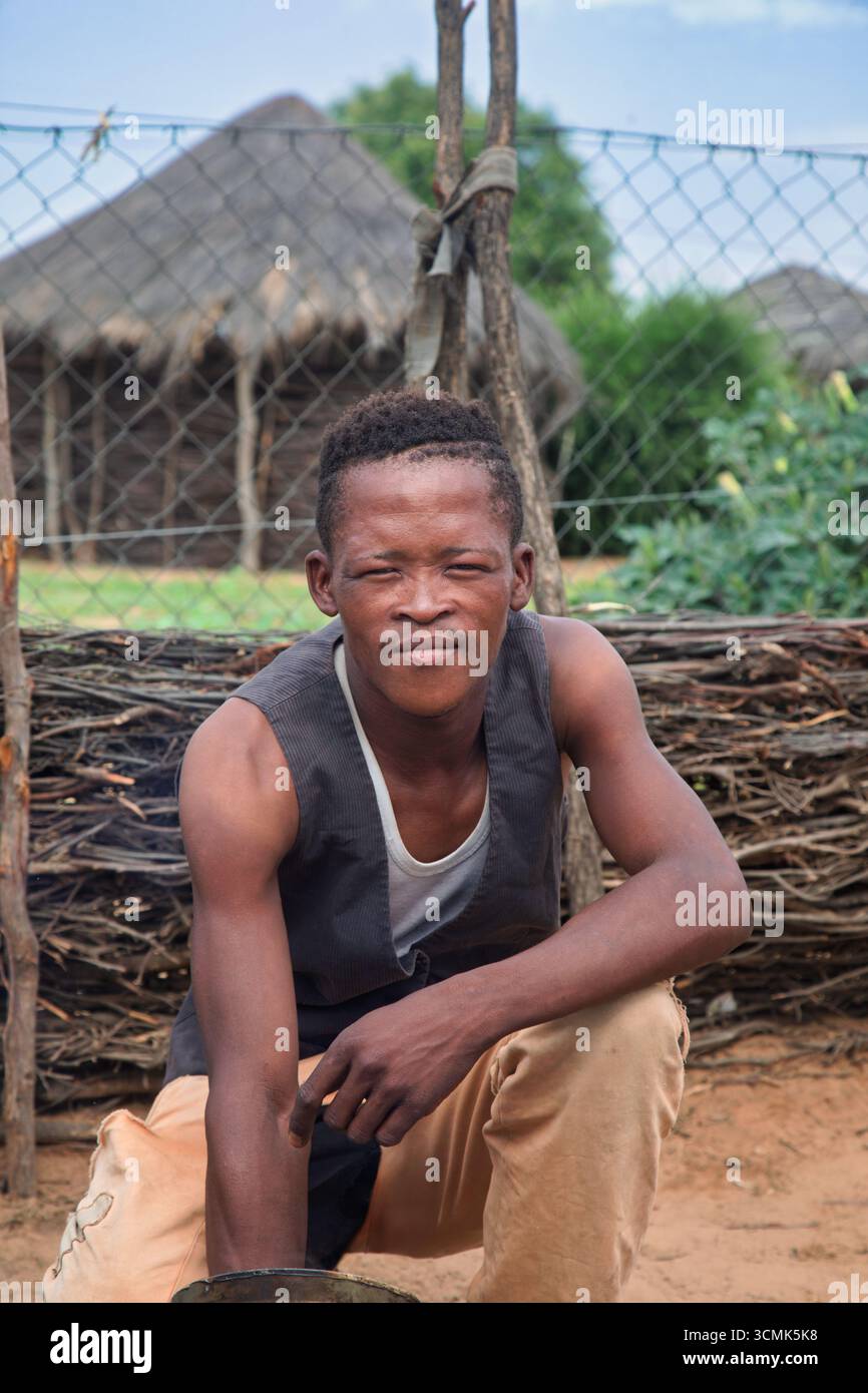 african village single smiling young african man, in front of mud house ...