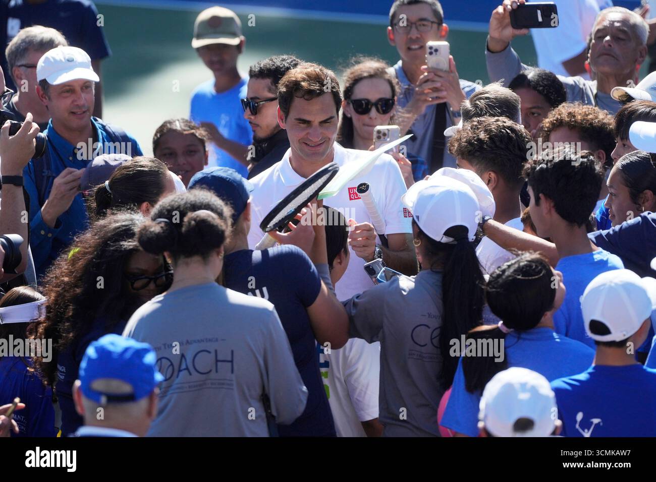 Co-creator of the Laver Cup Roger Federer, middle, signs autographs ...