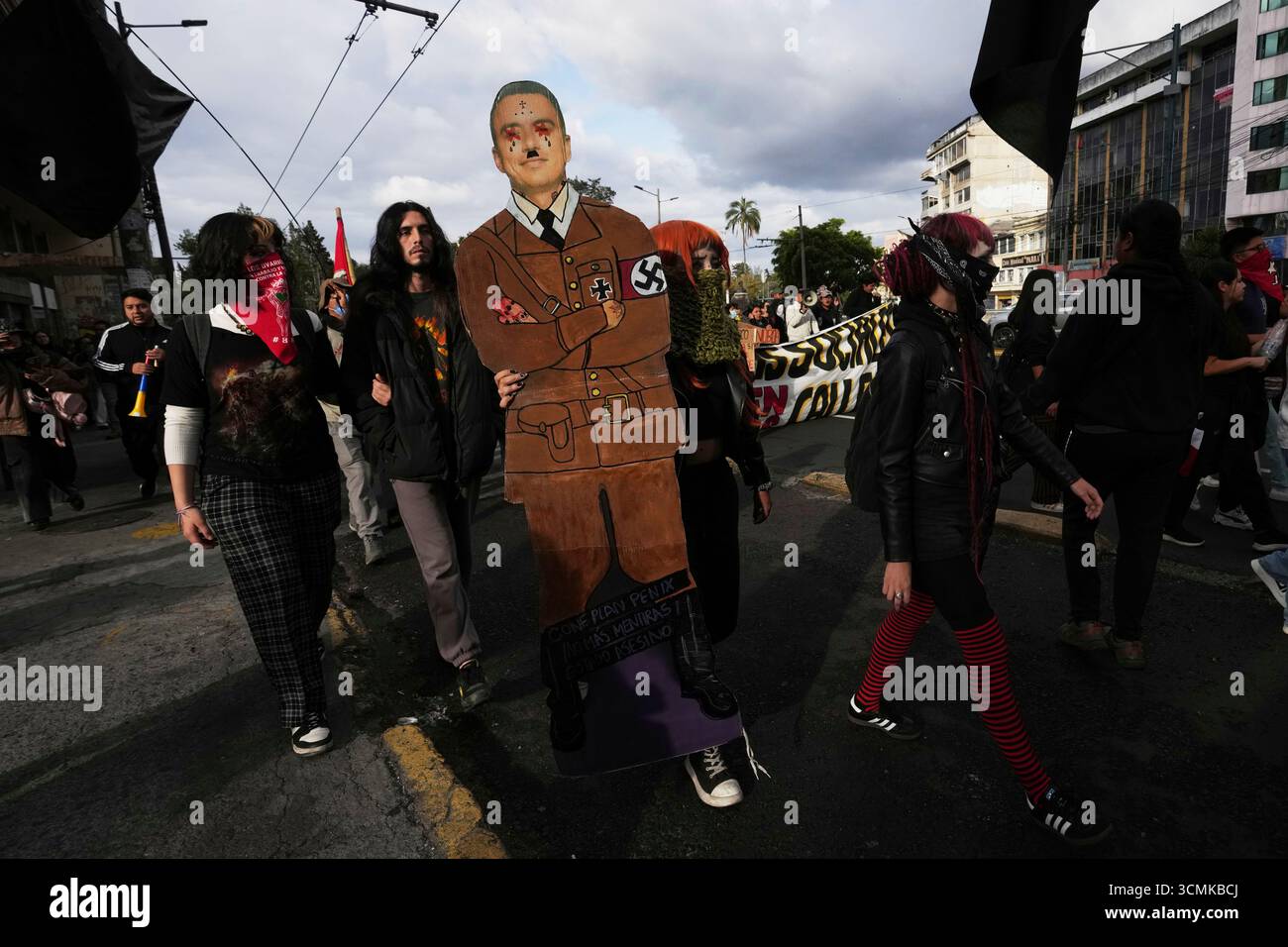 People hold a cutout of President Daniel Noboa dressed as Adolf Hitler ...
