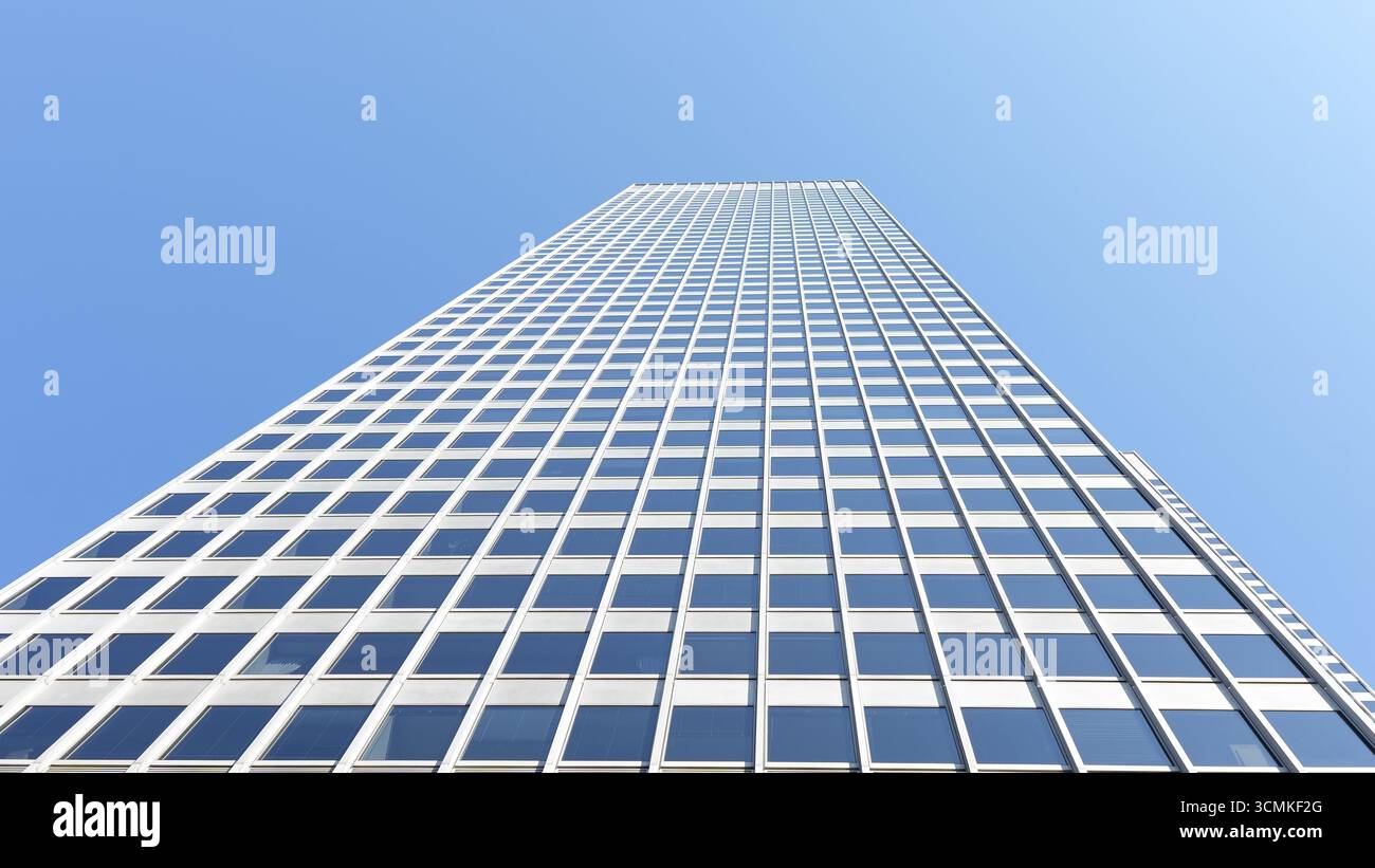 Modern skyscraper with reflective glass facade, viewed from below ...