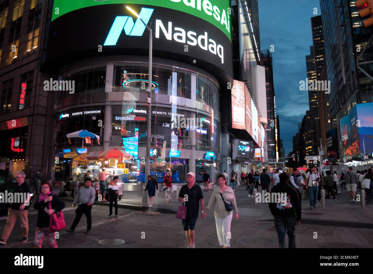 People walk past the Nasdaq MarketSite Times Square event space in ...